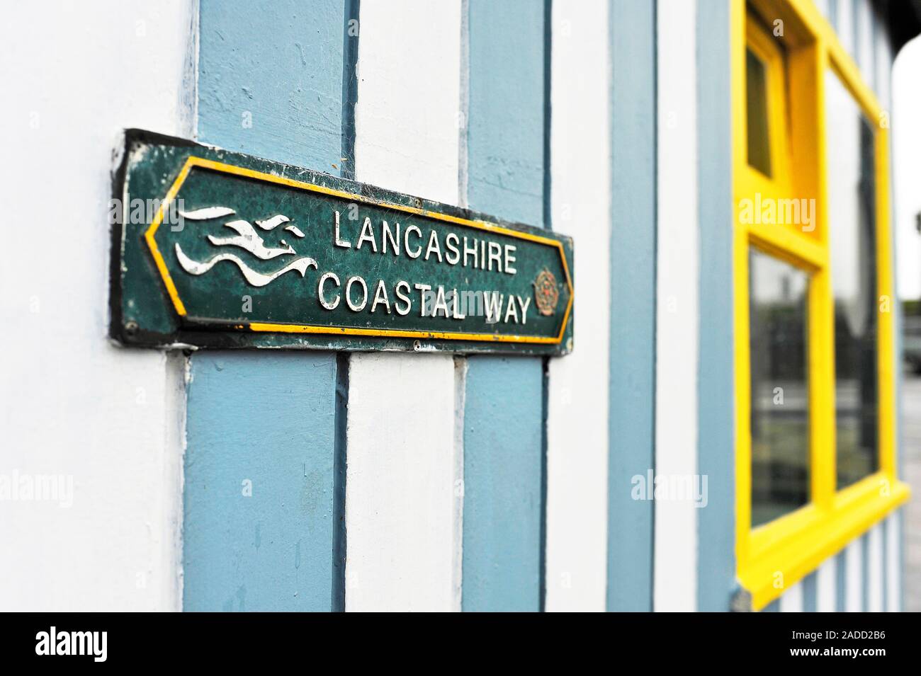 Lancashire coastal way sign attached to building with blue and white ...