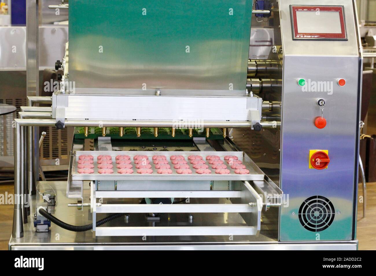 Making sweet cakes on a production line. A baking machine with a ...