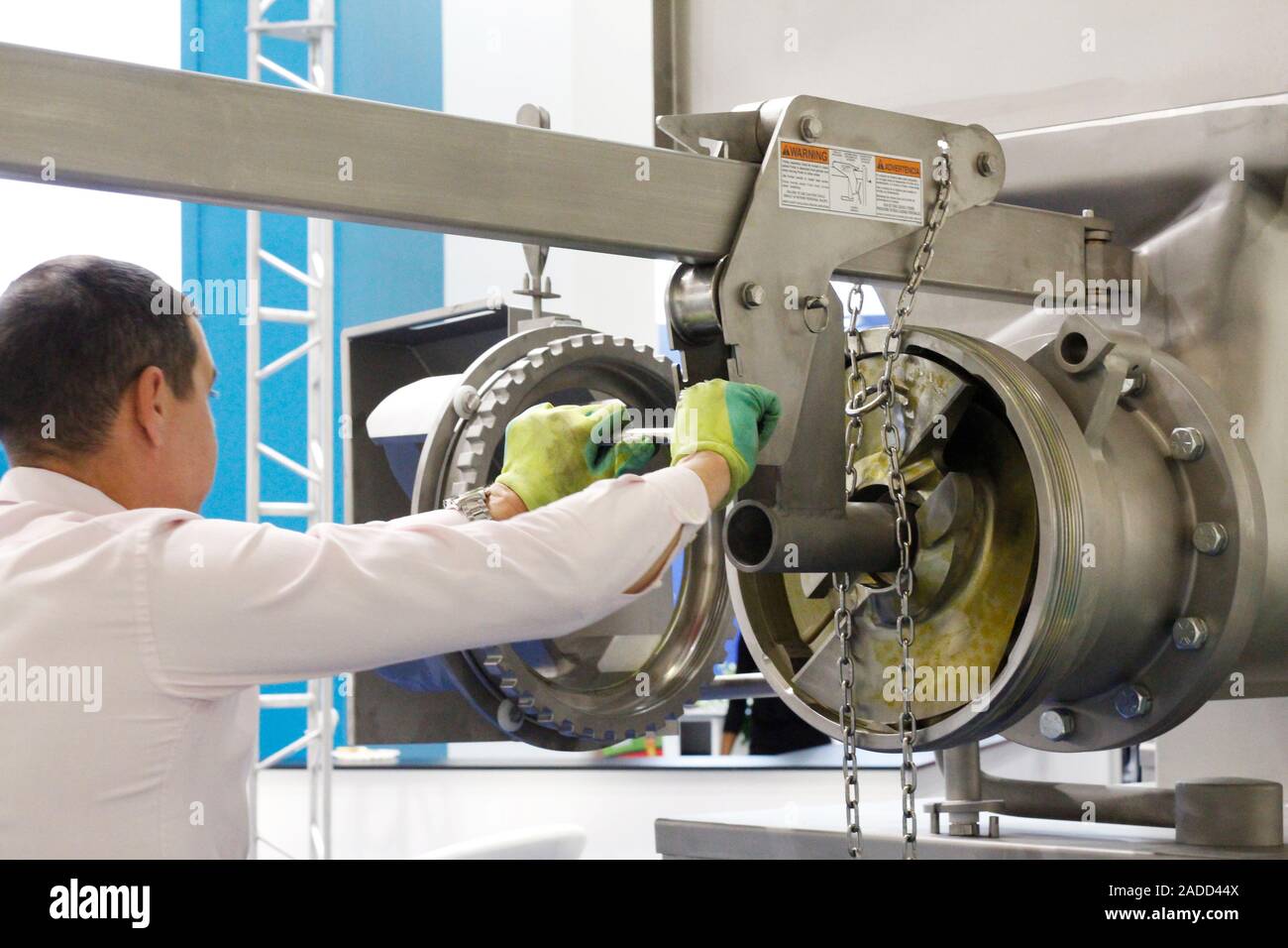 A craftsman is repairing industrial tape at a factory. Troubleshoot ...
