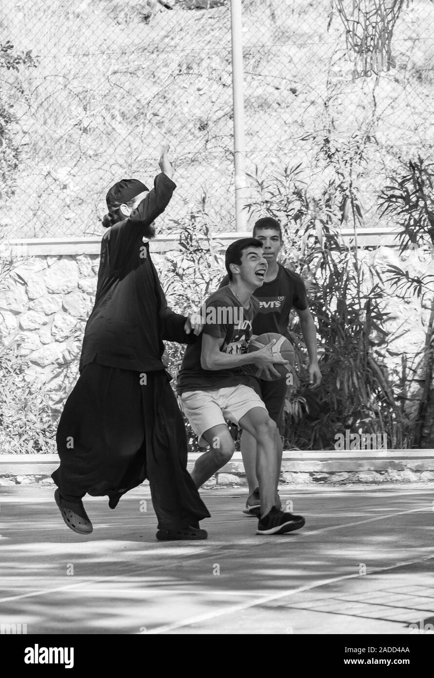 Greek orthodox priest playing basket with children Stock Photo - Alamy