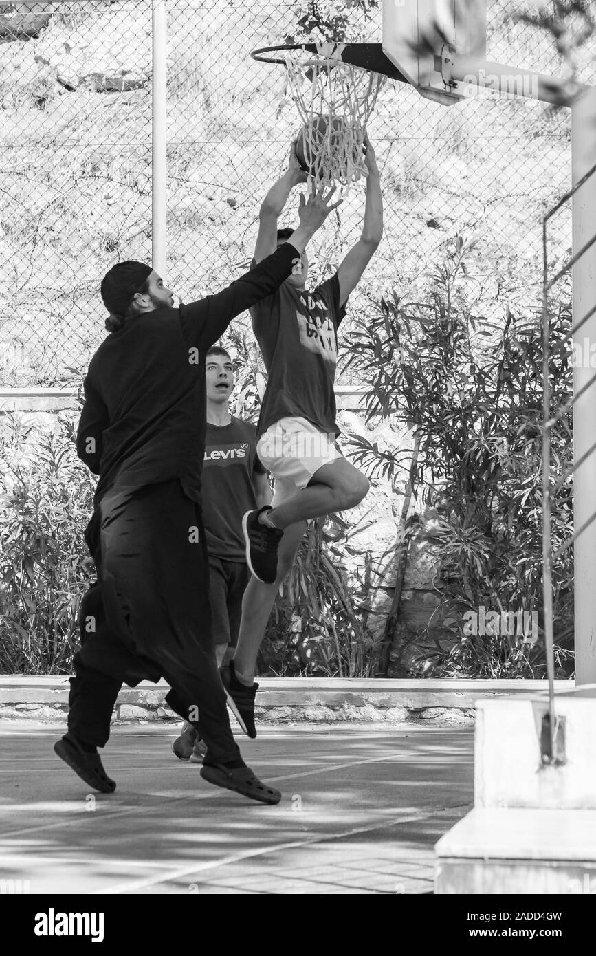 Greek orthodox priest playing basket with children Stock Photo - Alamy