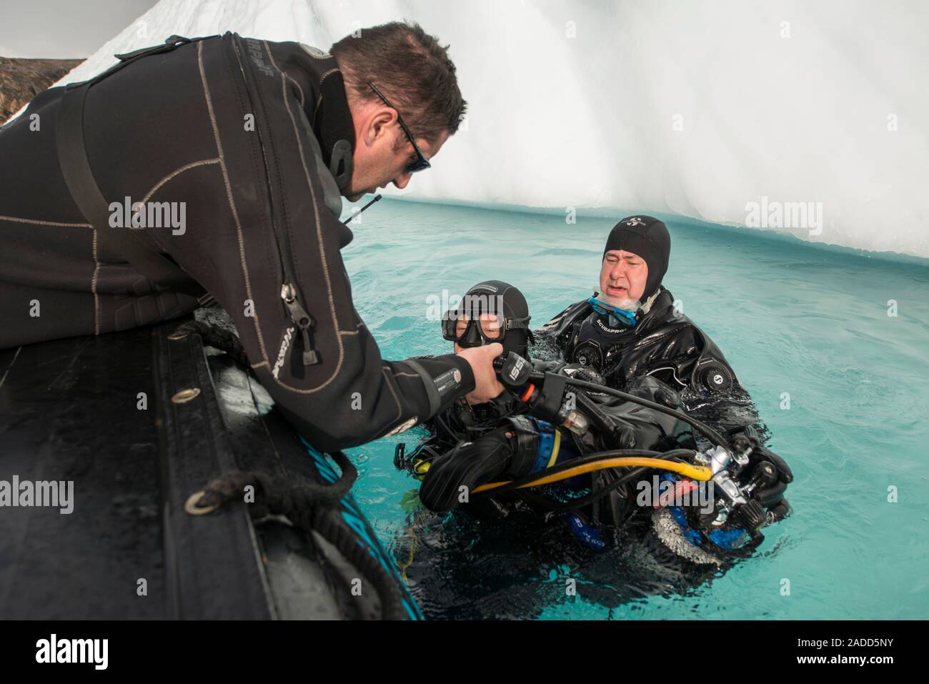 SCUBA diving next to melting iceberg near Danmark Island in a fjord in ...