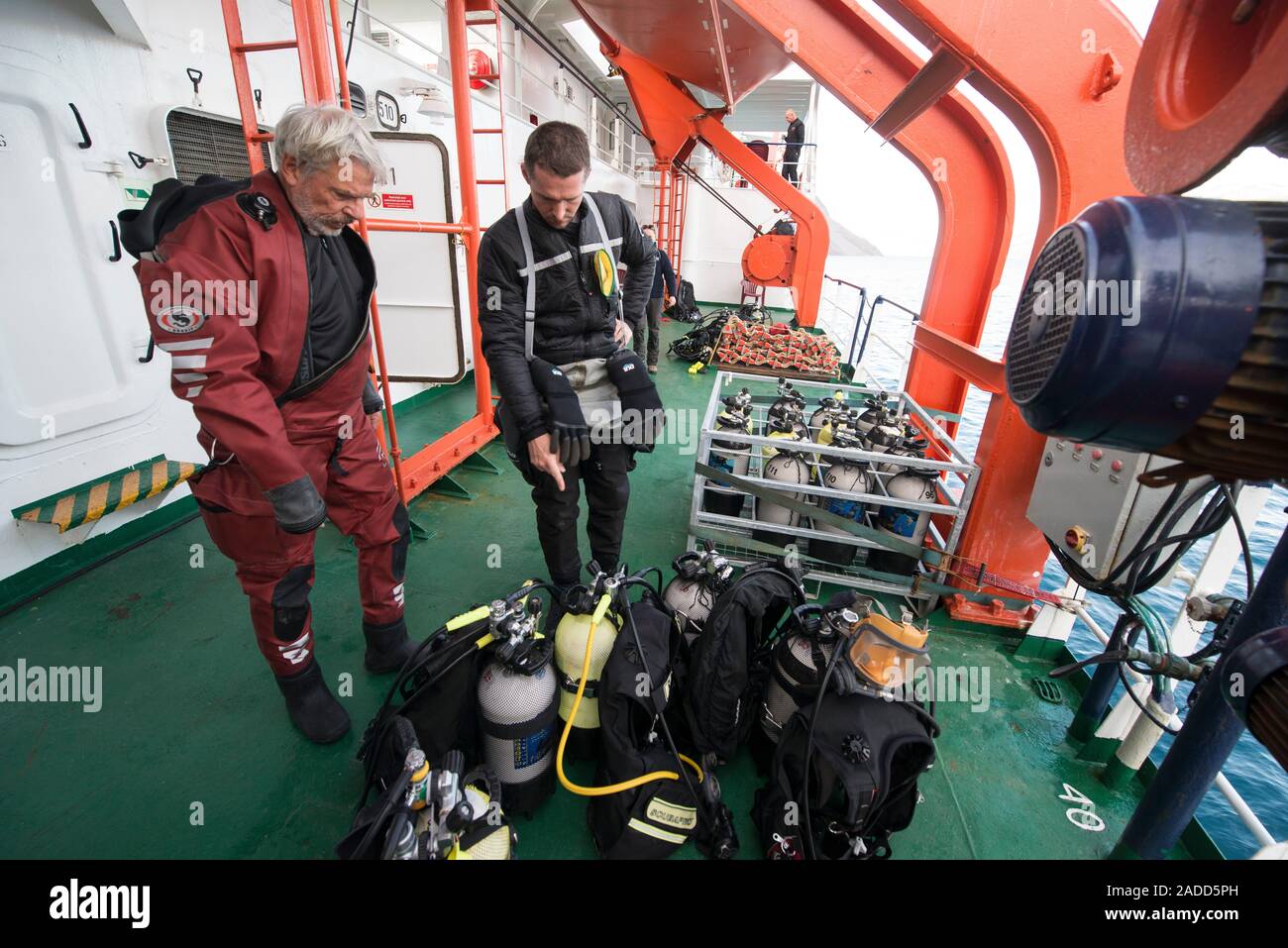 SCUBA divers preparing equipment on board ship, Eastern Greenland Stock ...