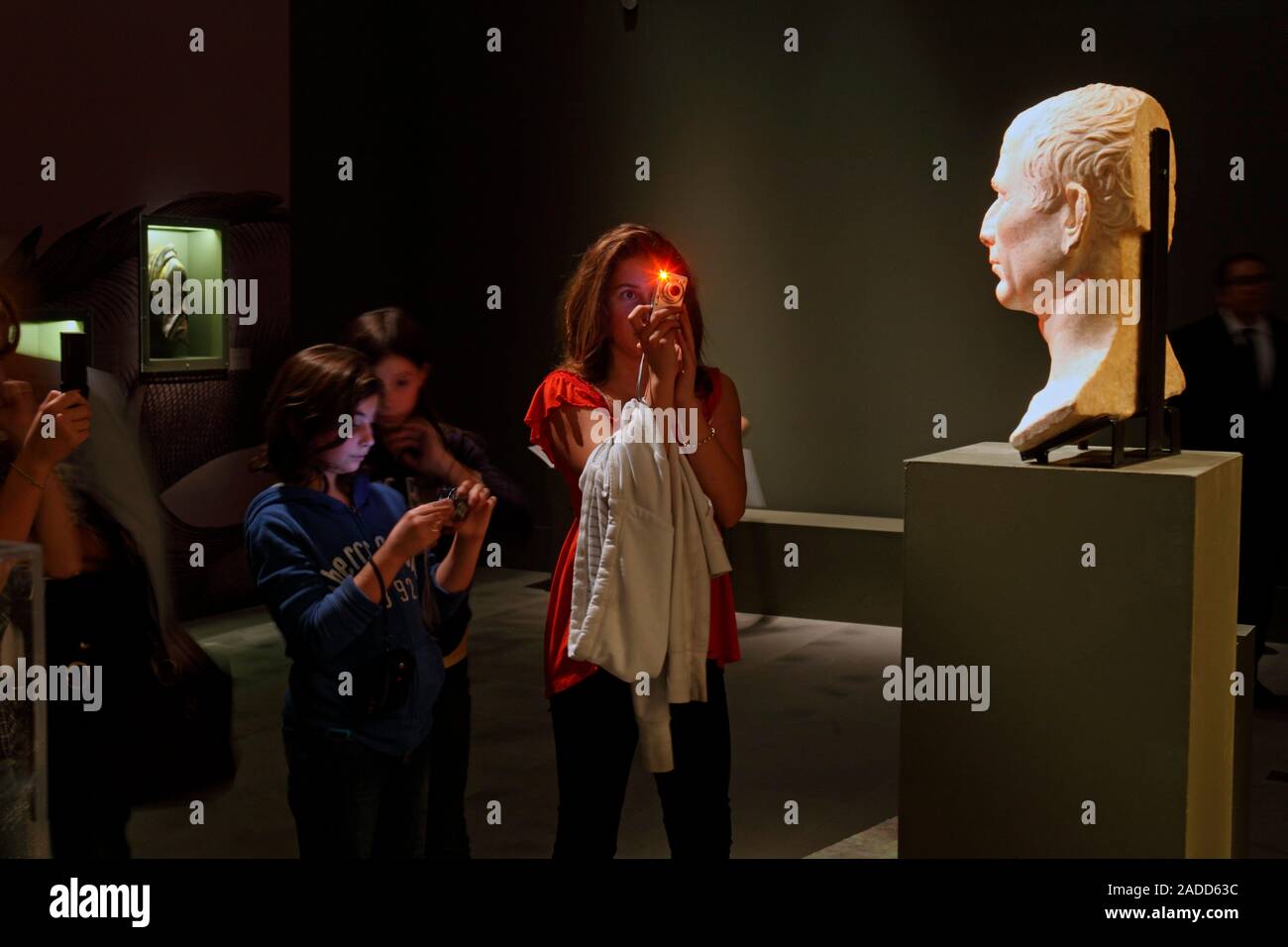 Arles Archaeology museum. Visitors viewing a marble bust of the Ancient ...