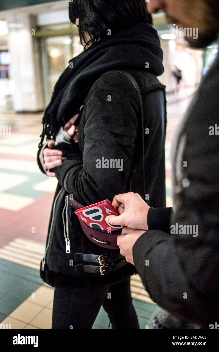 Pickpocket. Person stealing a young woman's wallet from her bag Stock ...