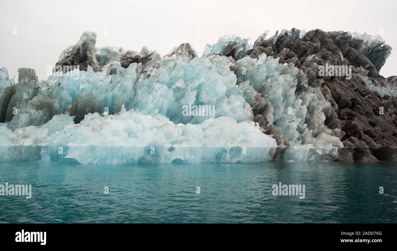 Discoloured iceberg. This is a result of the glacier from which it ...