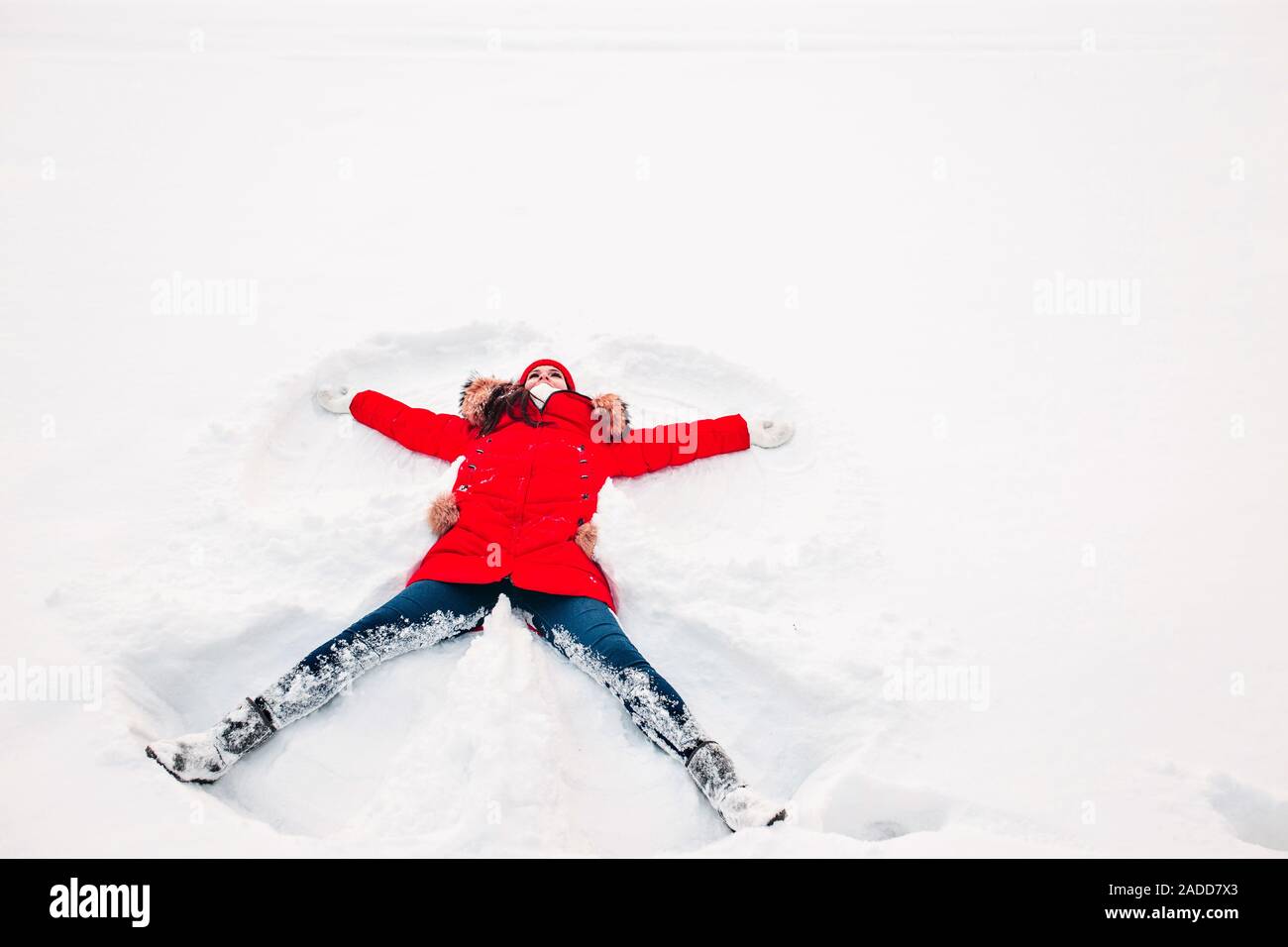 Snow angel made by a woman in the snow. Top flat overhead view Stock ...