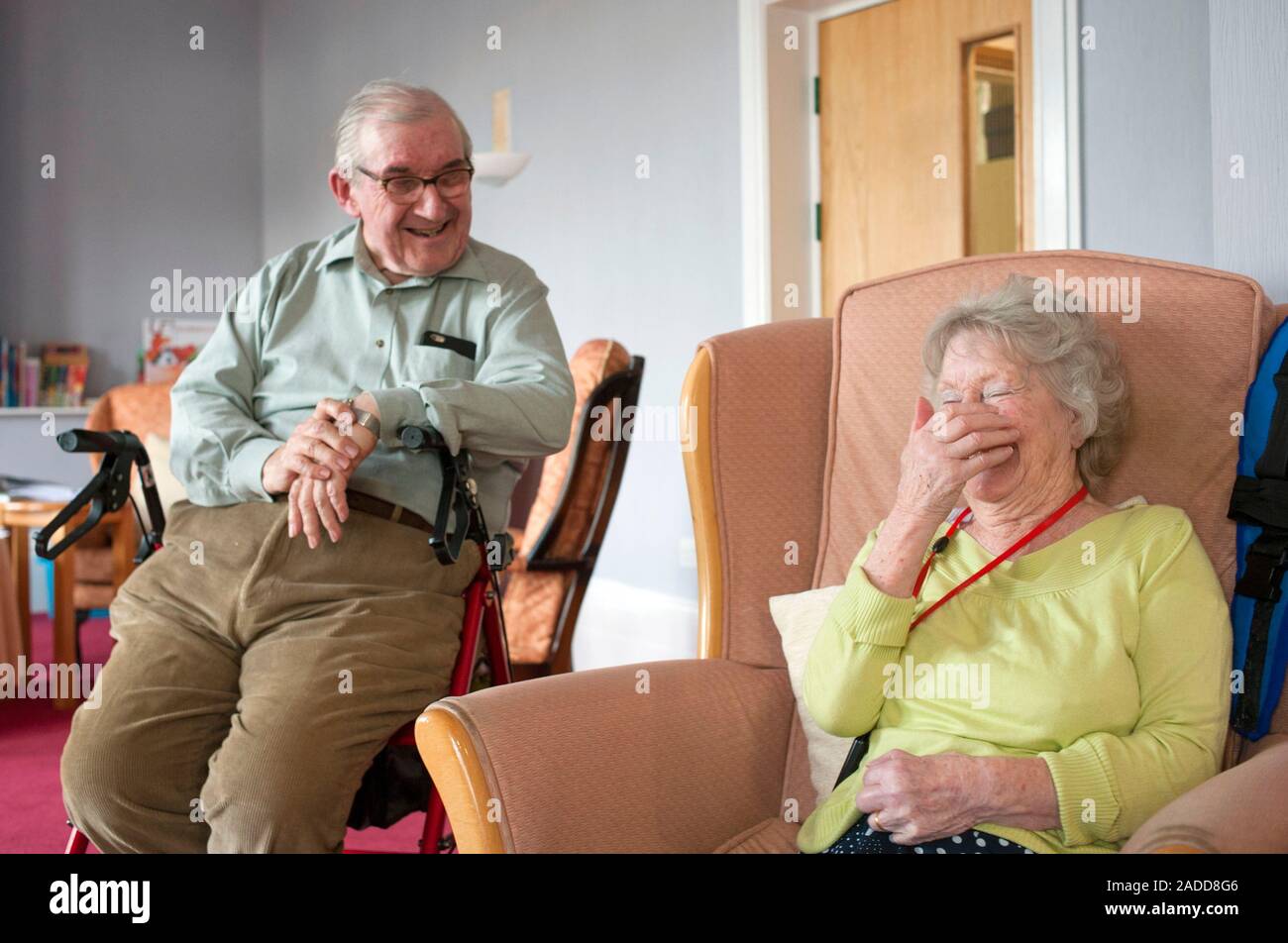 MODEL RELEASED. Care home residents laughing. 77-year-old man and 85 ...