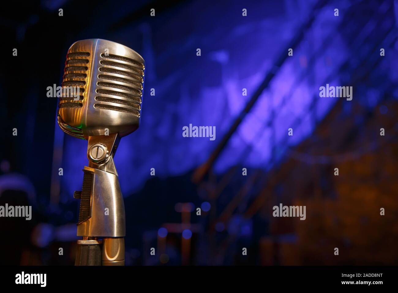 Retro microphone against dim blue light restaurant background Stock ...