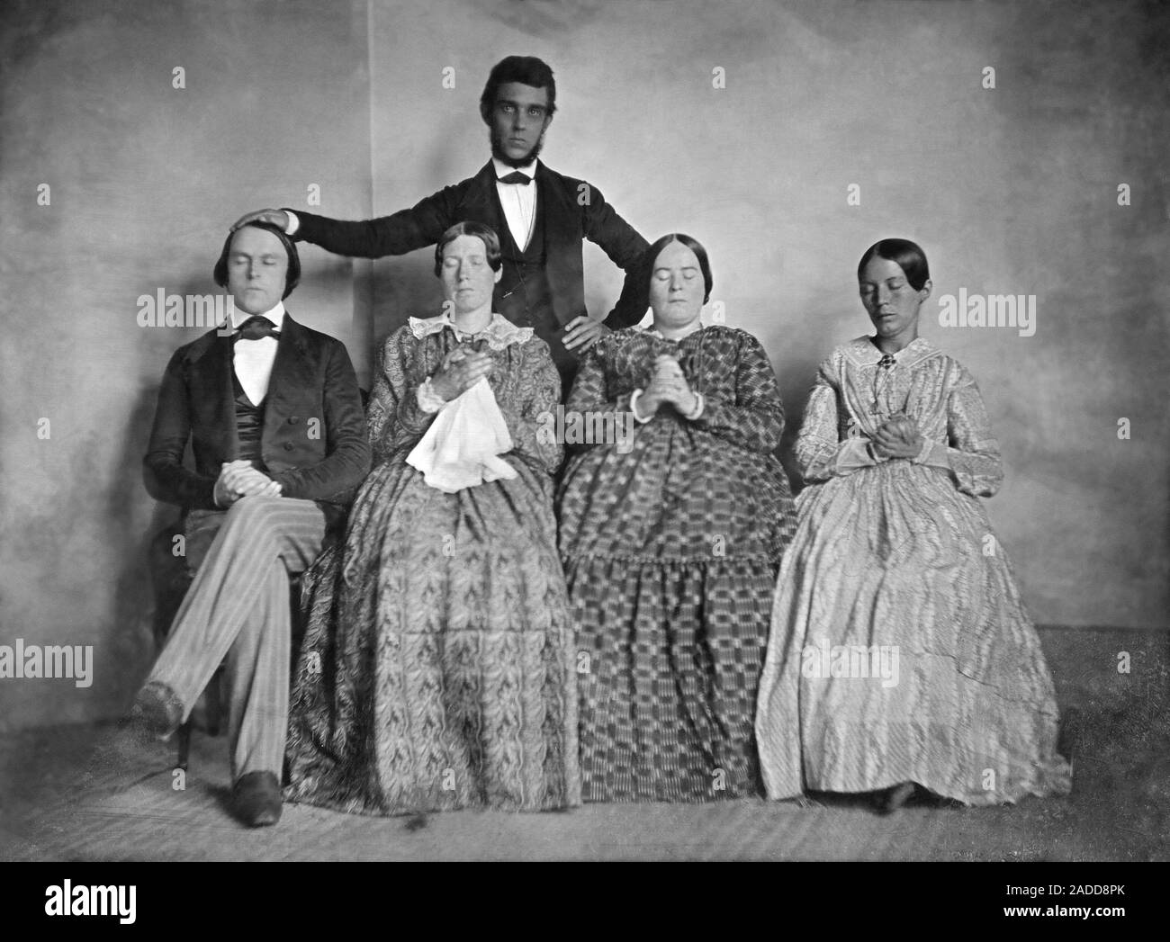 Hypnotism session. Daguerreotype showing four people being hypnotised ...