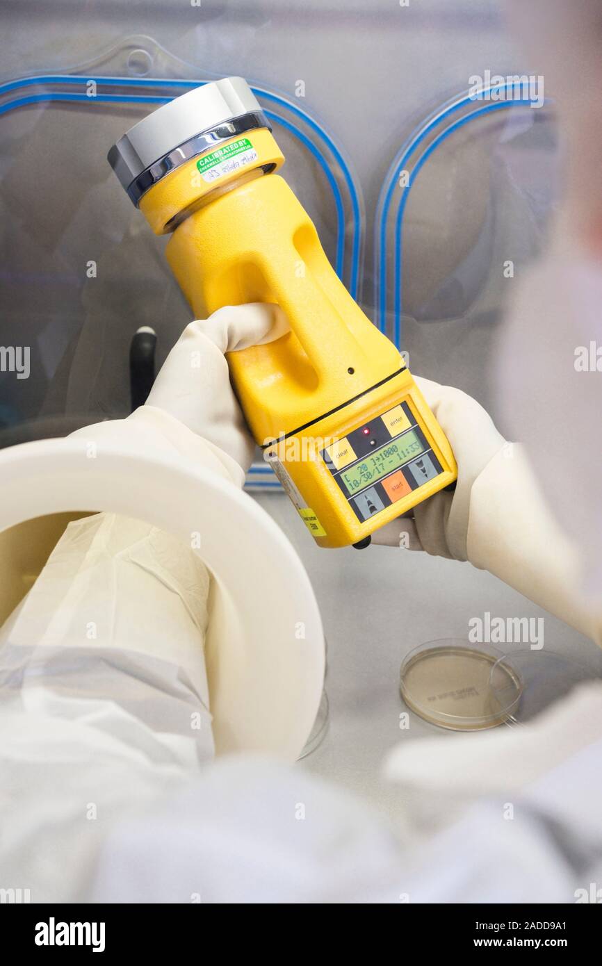 Air sampling in faecal microbiota transplant research. Researcher using ...