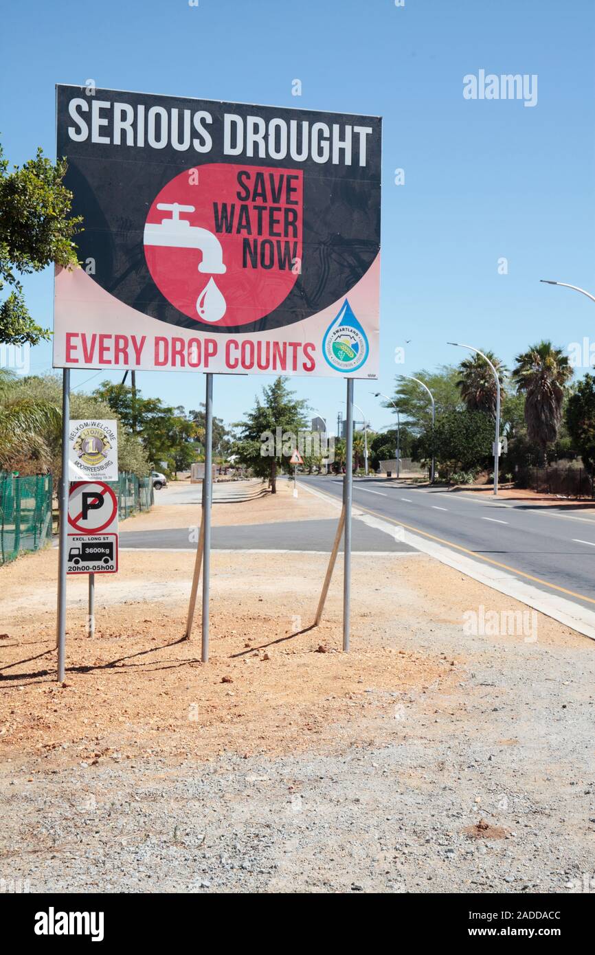 Drought sign. Sign by the side of a road asking people to save water ...