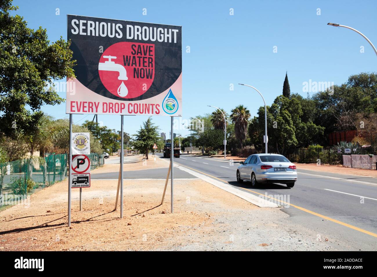 Drought sign. Sign by the side of a road asking people to save water ...