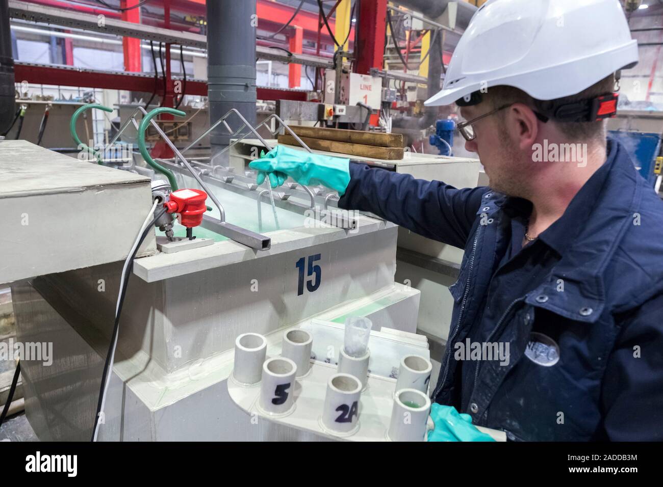 Electroless nickel plating factory. Worker checking the chemical ...