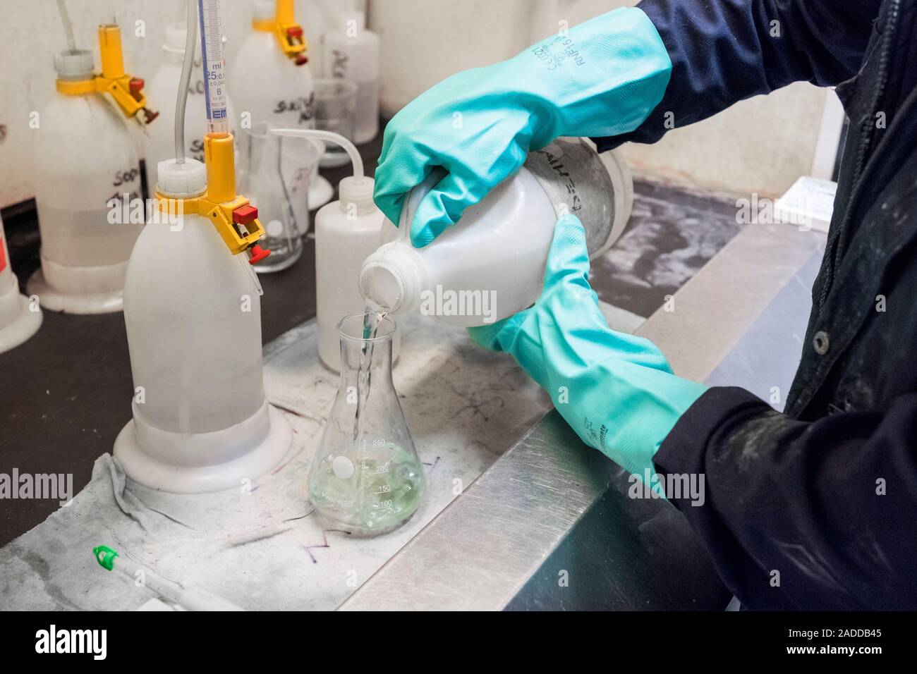 Electroless nickel plating factory. Worker testing chemical samples for ...