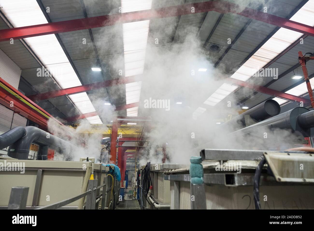 Electroless nickel plating factory. Chemical tanks and rinse tanks at a ...