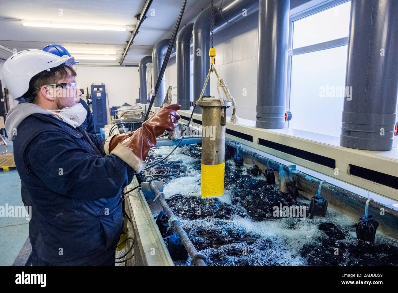 Copper plating factory. Products in chemical plating tanks at a factory ...