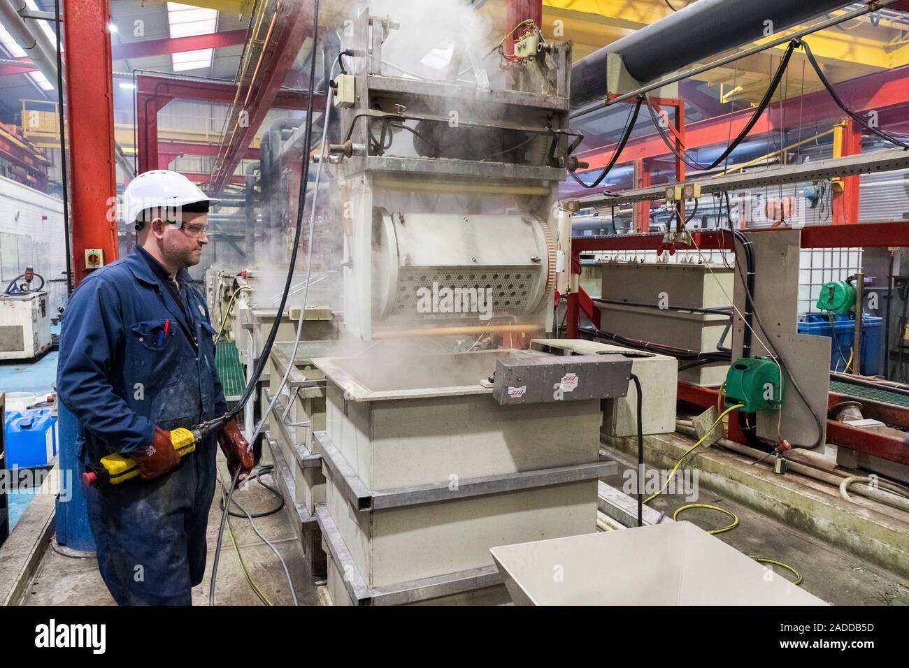 Electroless nickel plating factory. Worker with nickel plating chemical ...