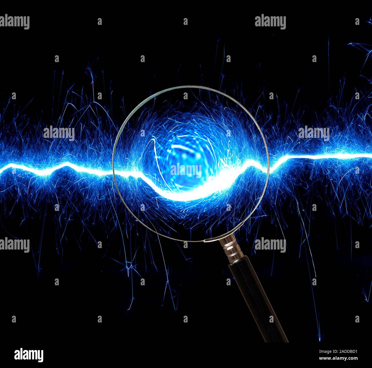 Electricity research. Conceptual image of a magnifying glass and ...