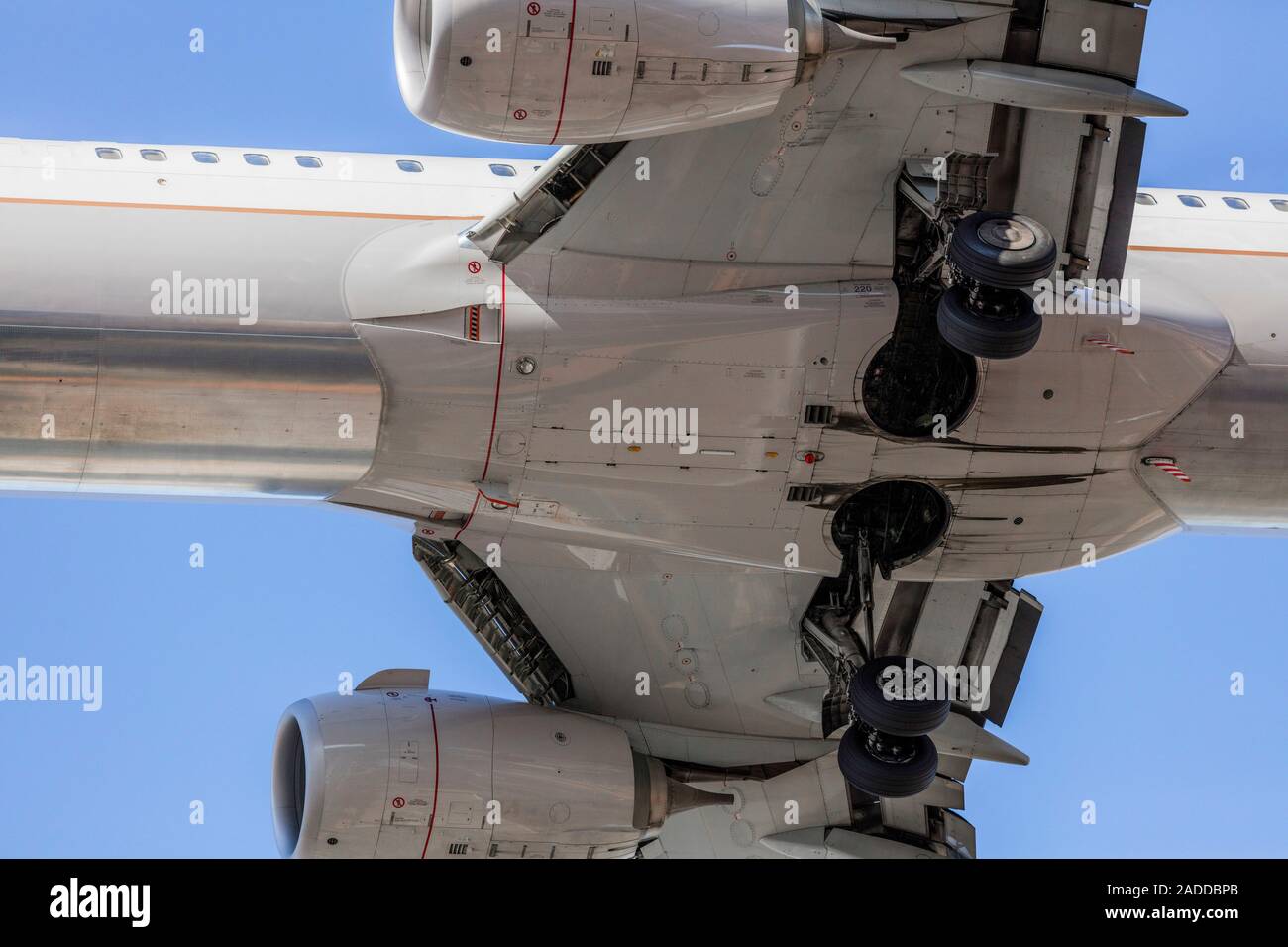 Commercial passenger jet coming in for landing seen from below. Landing ...