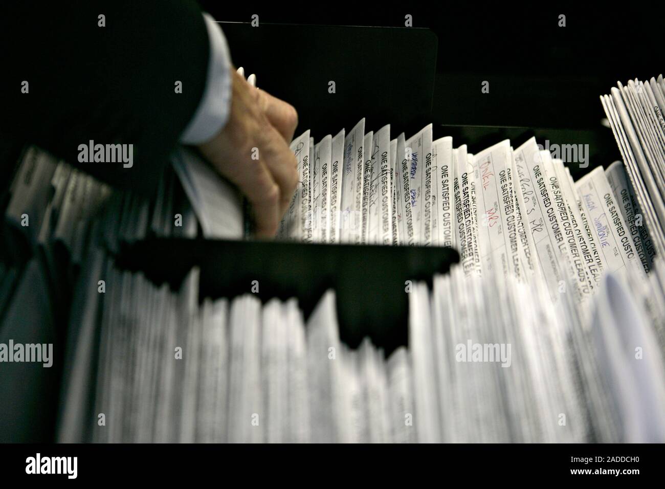 Worker looking through files in a filing cabinet Stock Photo - Alamy