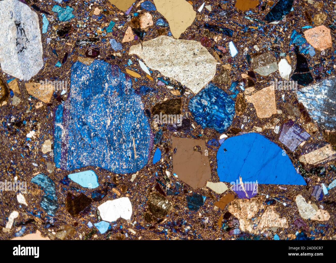 Rhyolite mineral rock crystals, polarised light micrograph. This rock ...