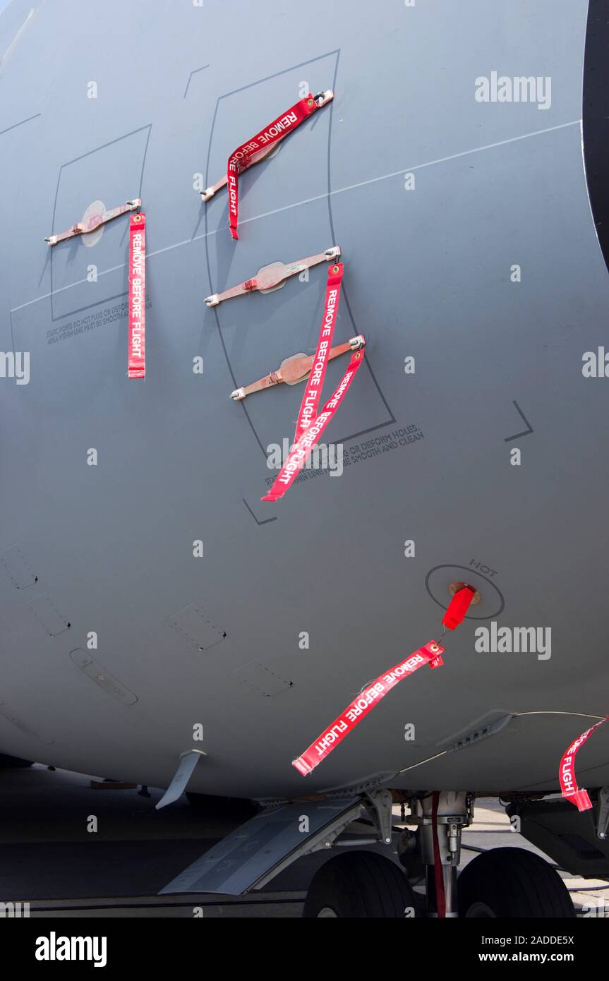 Six red, remove-before-flight tags on a military transport aircraft on ...