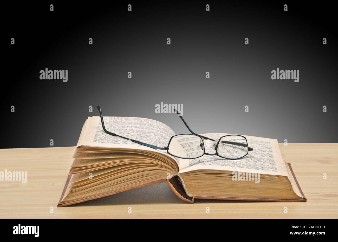 Eyeglasses on open book Stock Photo - Alamy