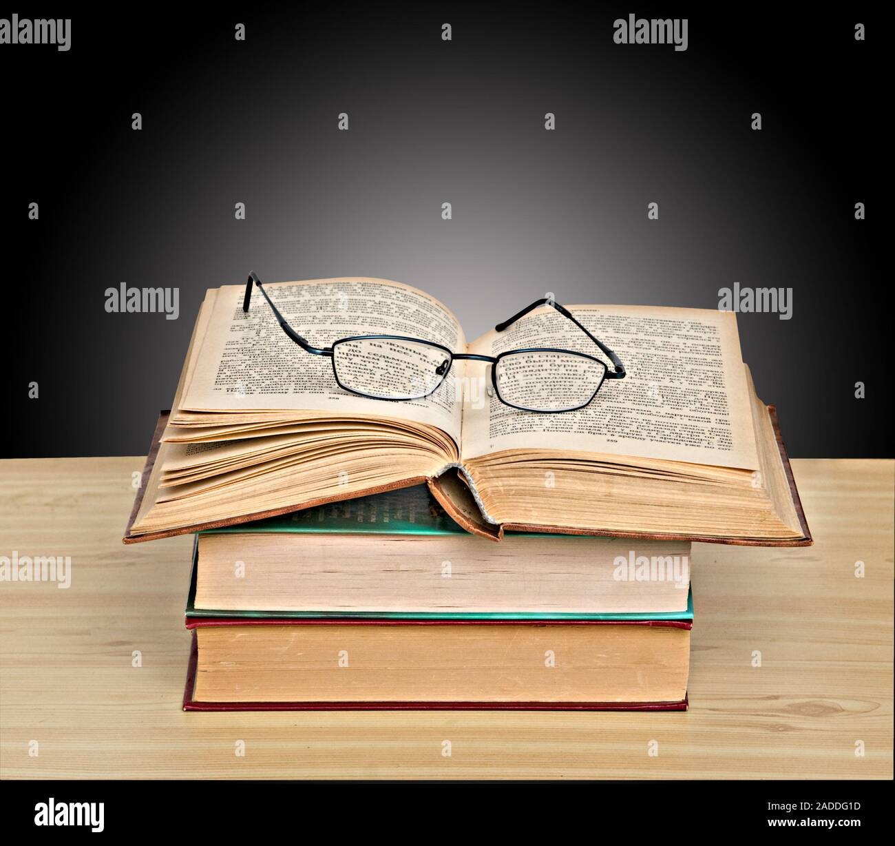 Eyeglasses on open book Stock Photo - Alamy