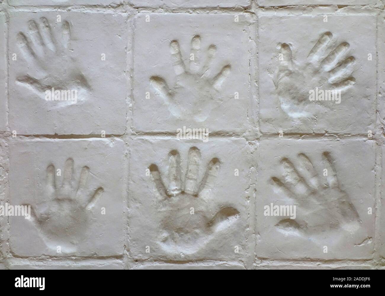 Hand prints in plaster Stock Photo - Alamy