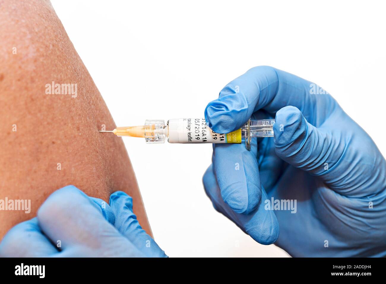 Influenza vaccine injection. Injection into a patient's arm of the 2018 ...