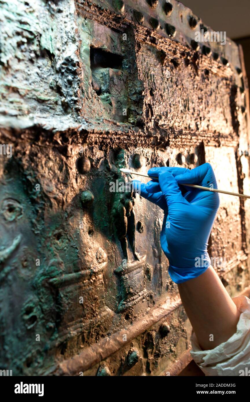 Restoration of Roman bronze box from Pompeii. Restorer working on a ...