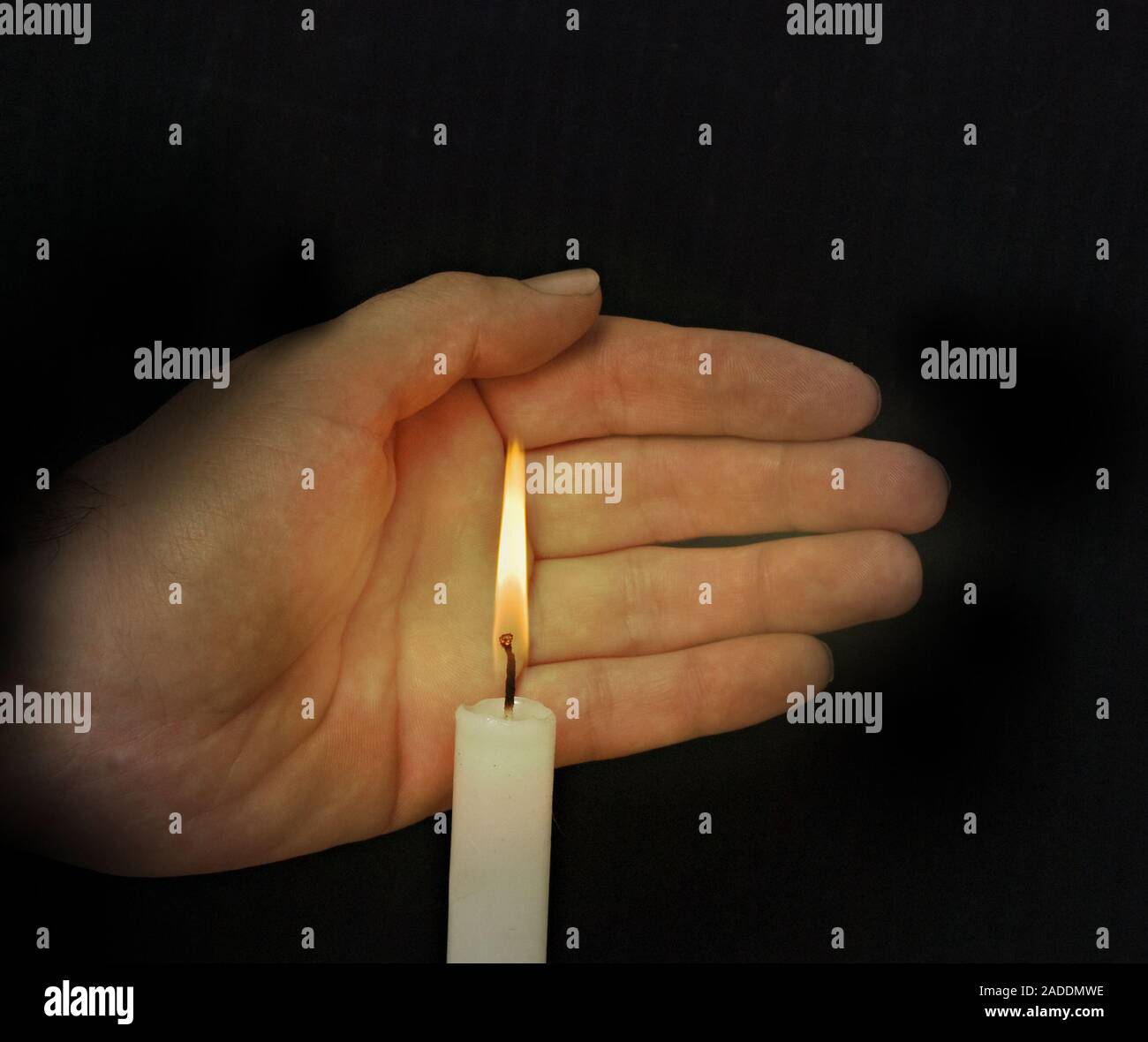 Candle and hand Stock Photo - Alamy