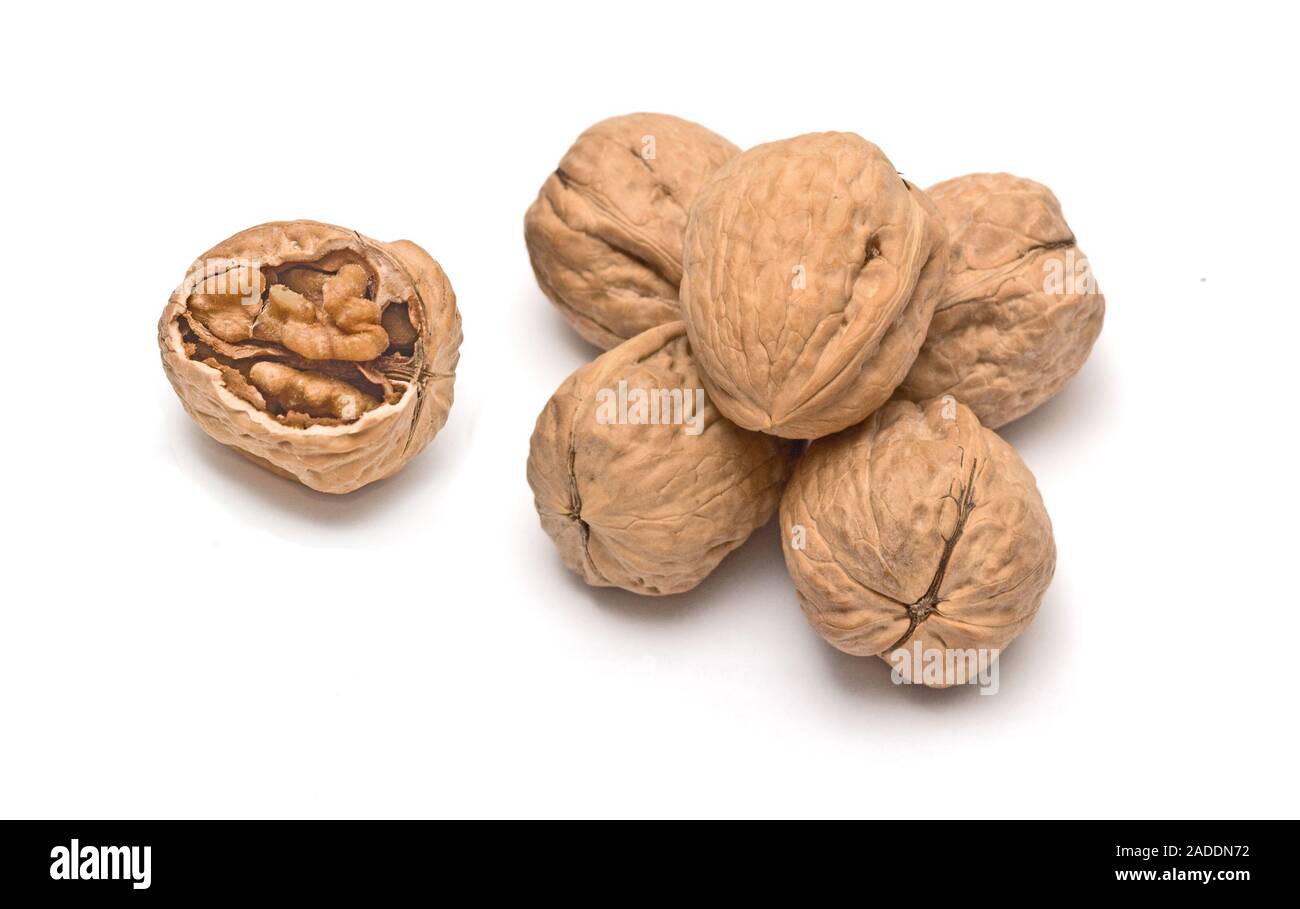 Cracked walnut and pile of walnuts isolated on white background Stock ...