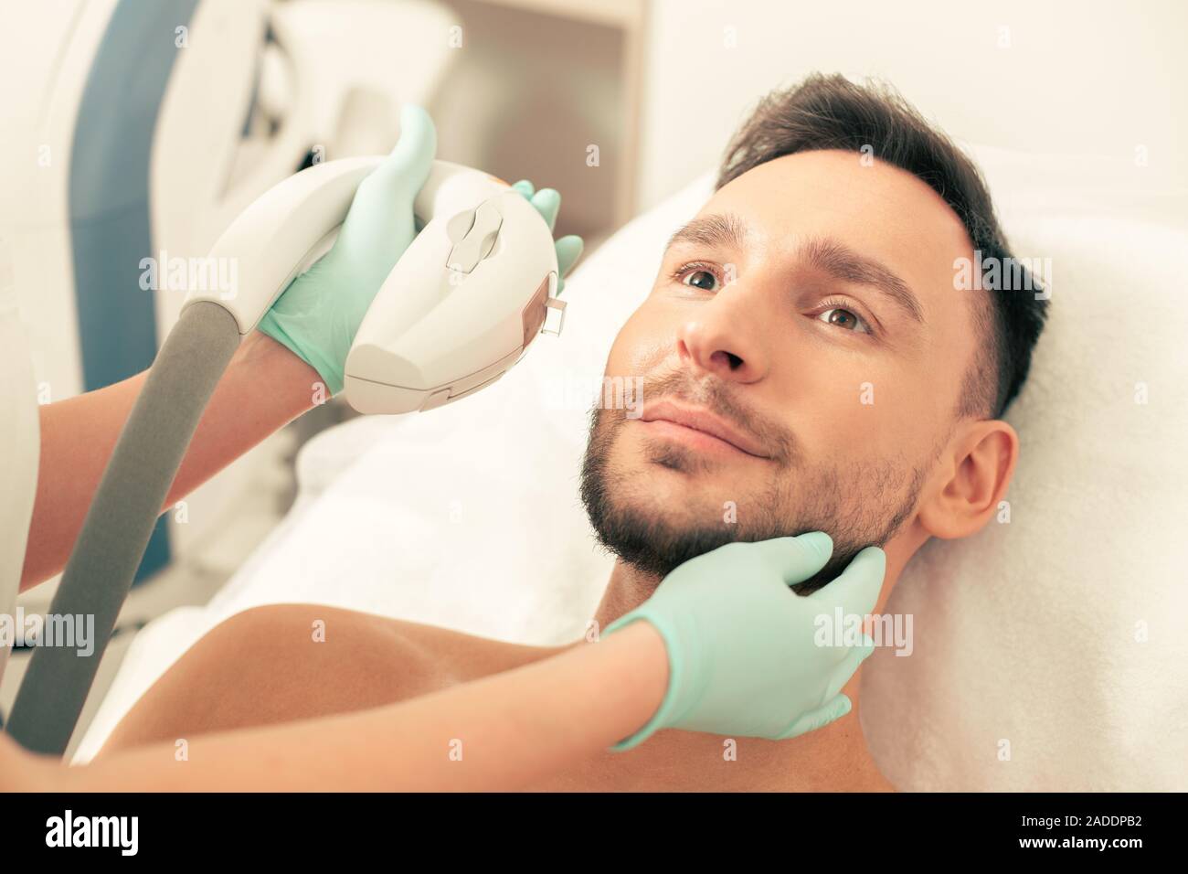 Hand of beautician touching the face of man during the procedure Stock ...