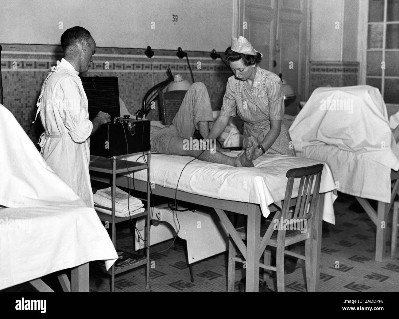 Electric therapy. Man's leg being treated by using electricity; this ...