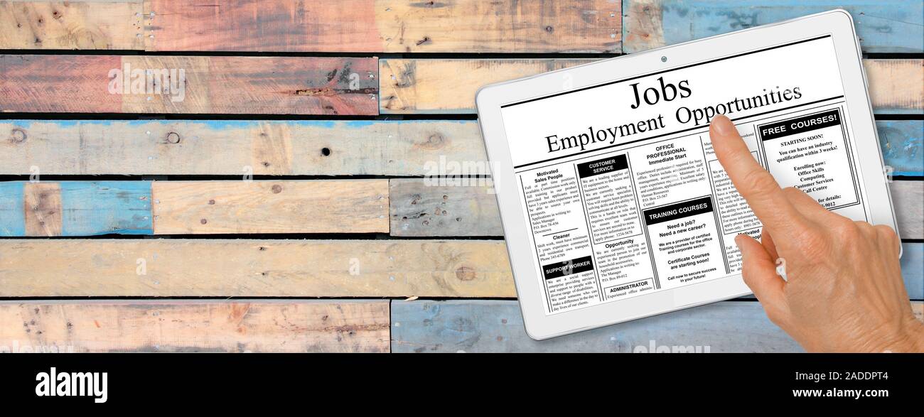 Online job hunting Hand with computer tablet reading employment ads on ...