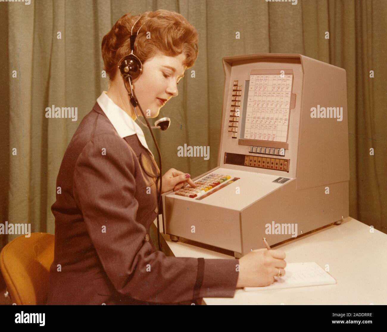 UNIVAC airline computer operator, 1960s. Airline employee using a ...