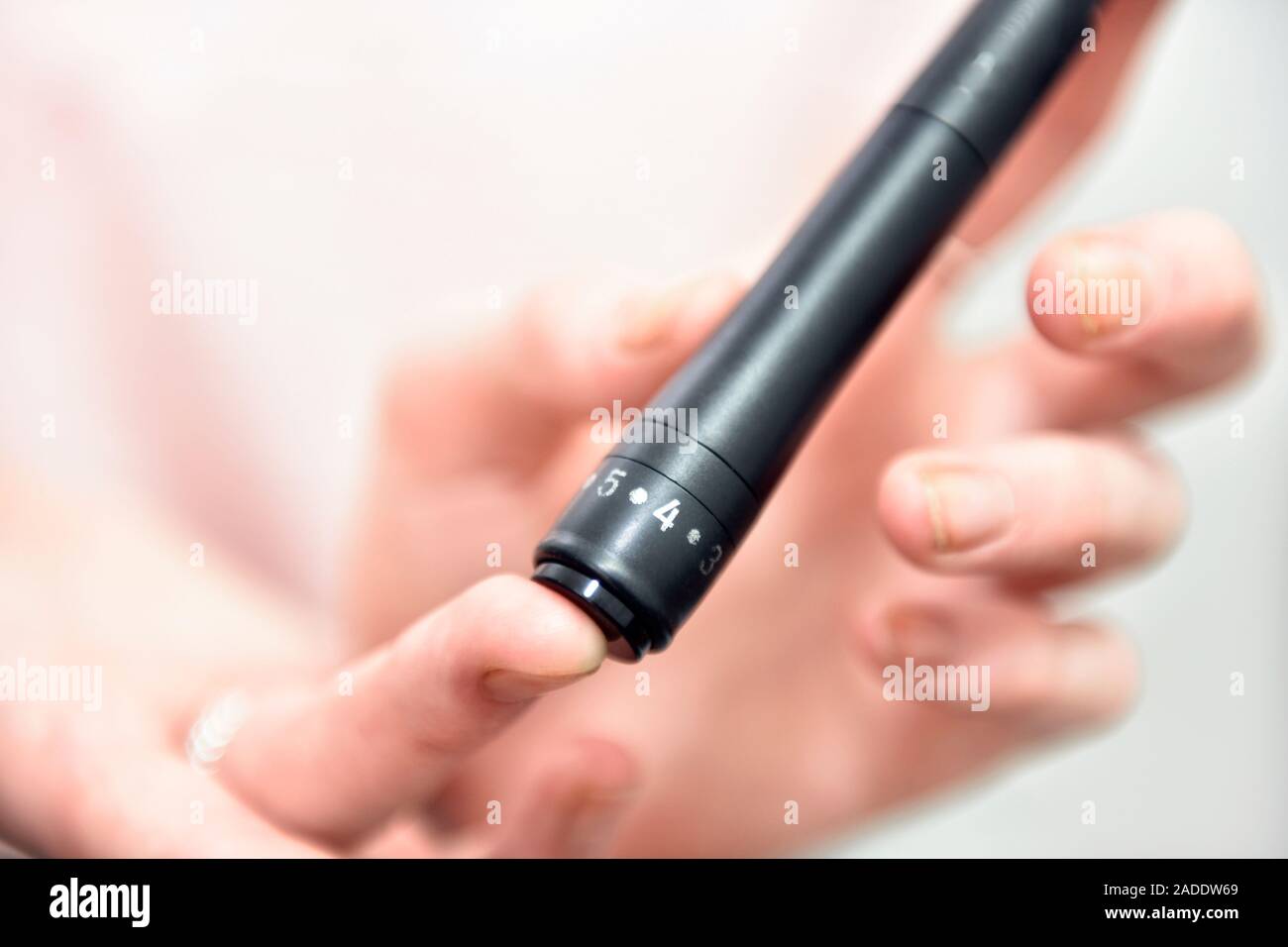 Blood sugar monitoring in diabetes. Close-up of a 16-year-old female ...