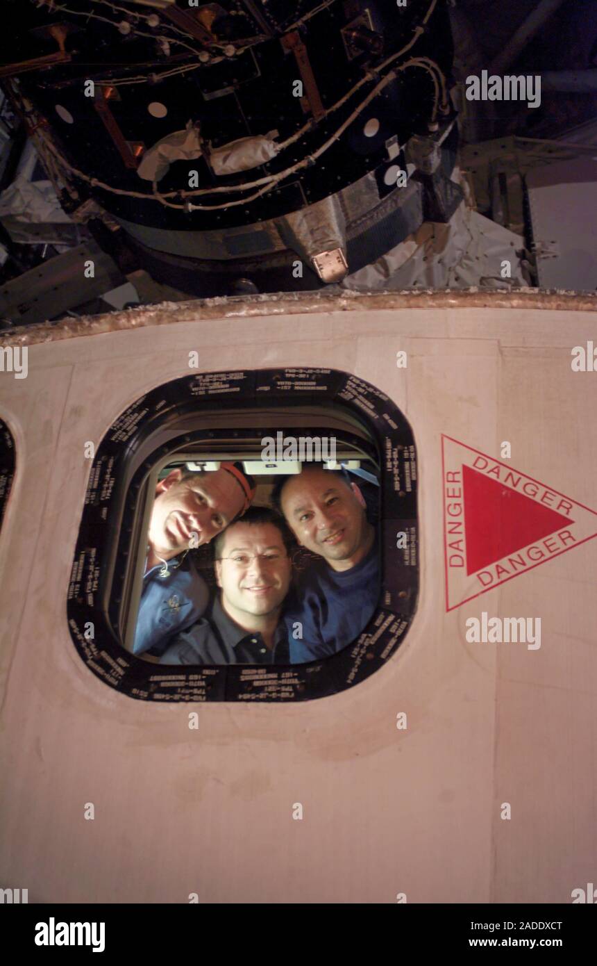Crew at a window of Space Shuttle Discovery, 2006. From the aft flight ...
