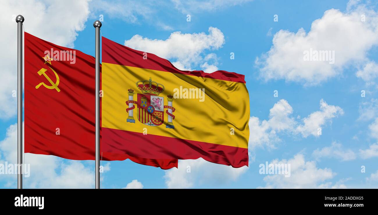Soviet Union and Spain flag waving in the wind against white cloudy ...