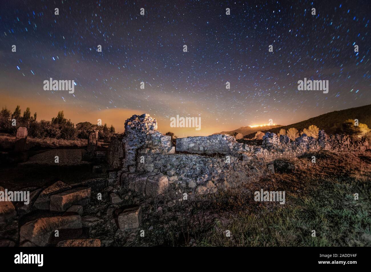 Night sky over Roman ruins, with light pollution on the horizon ...