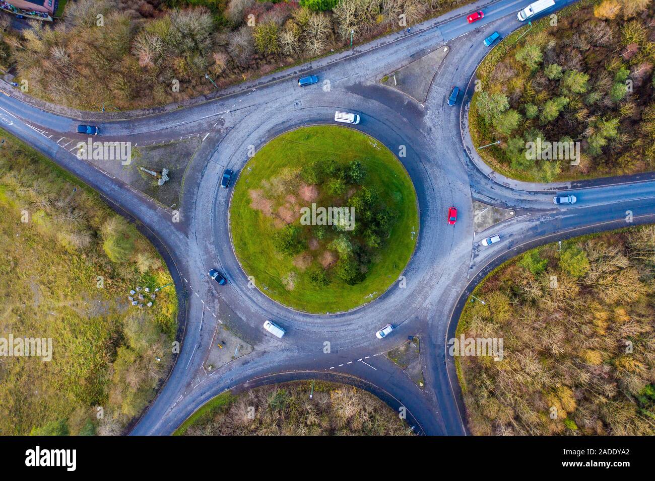 Top down aerial view of a traffic roundabout on a main road in an rural ...