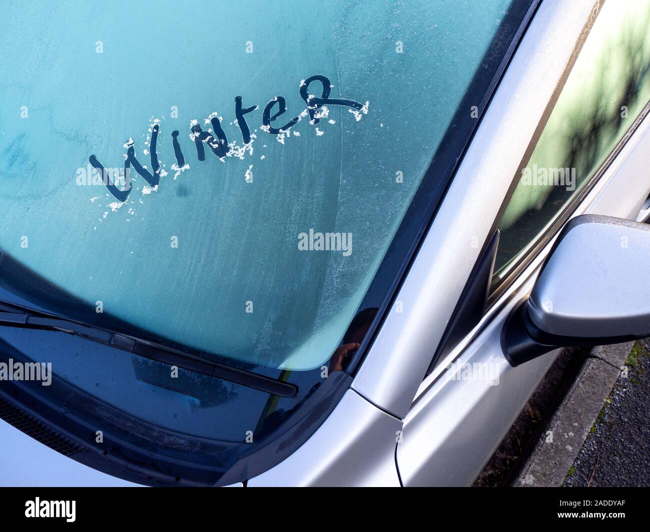 Winter written in the ice on a car windscreen on a cold frosty morning ...