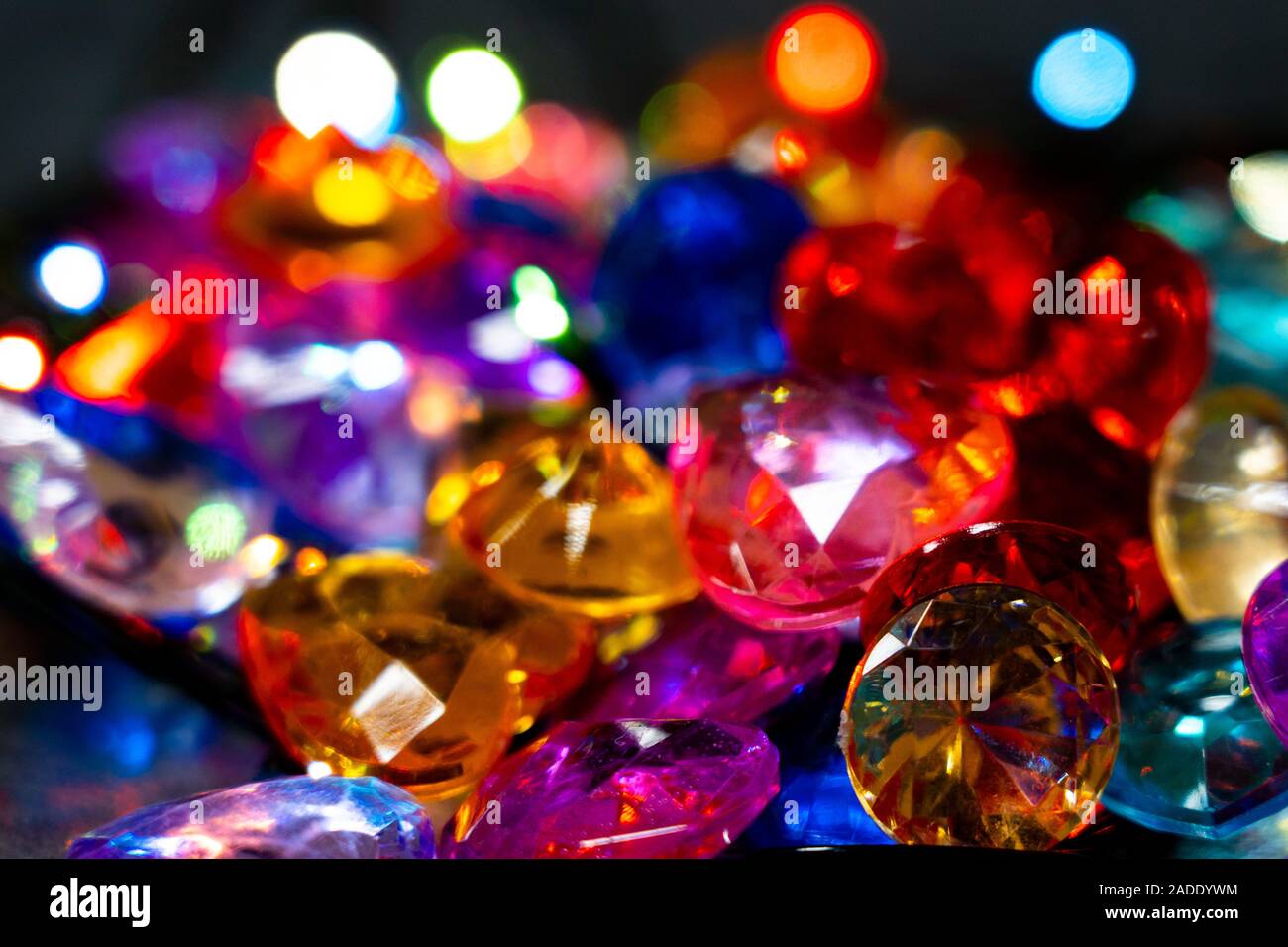 Multi-colored glass pebbles glow in the dark with bright saturated ...