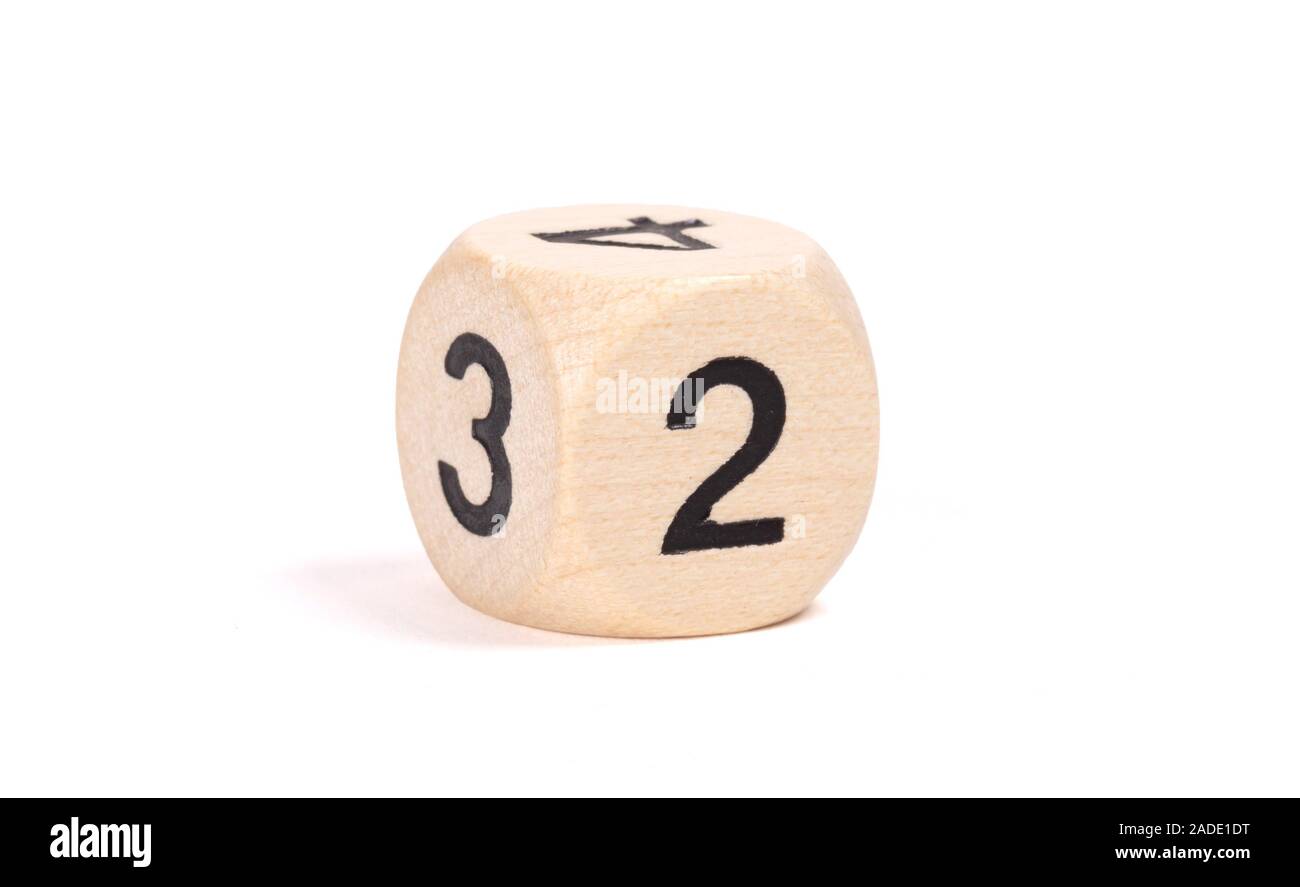 Small wooden dice, numbers written on it, isolated on white Stock Photo ...
