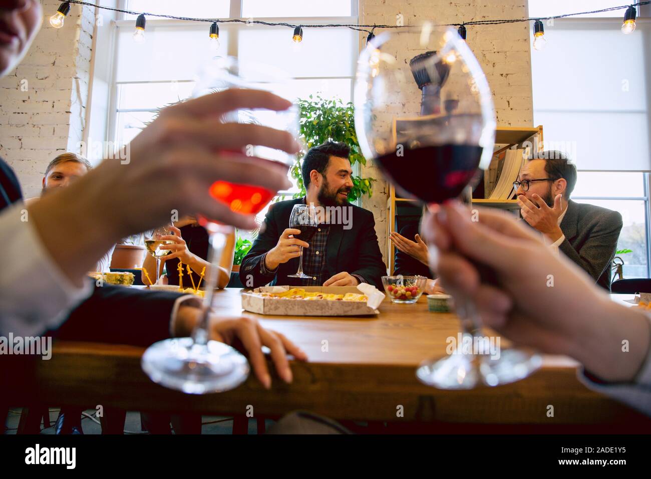 Happy co-workers celebrating while company party and corporate event ...