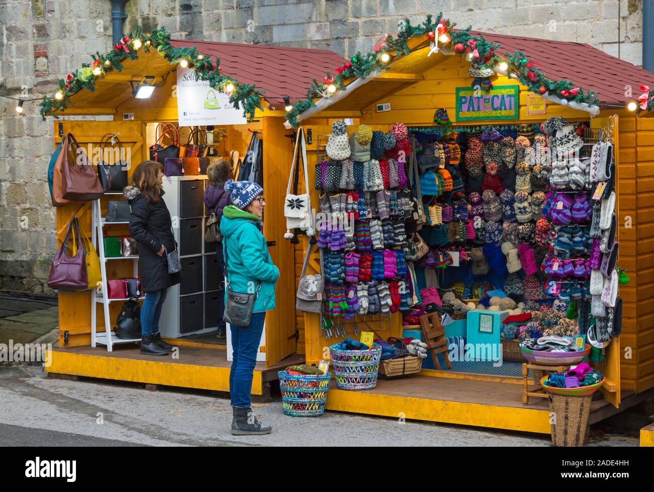 Market stall holders on hat and mittens stall & bags stall at ...