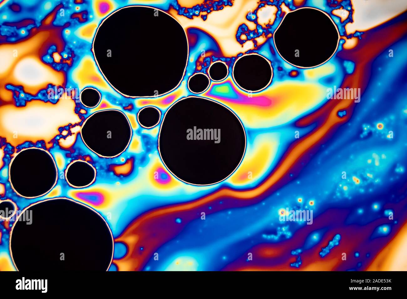 Soap bubble film iridescence. Light micrograph of the surface of a ...