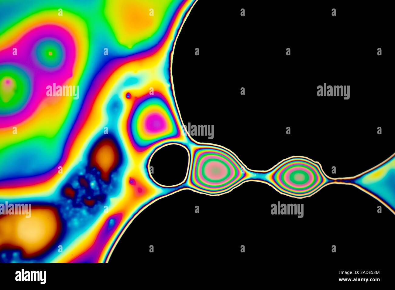 Soap bubble film iridescence. Light micrograph of the surface of a ...